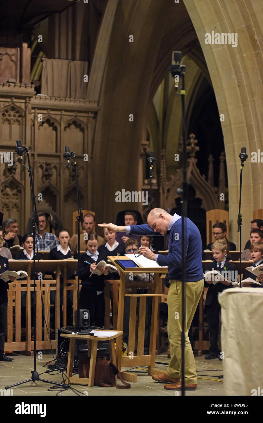 Choristers being conducted by choir master at a recording session for a ...