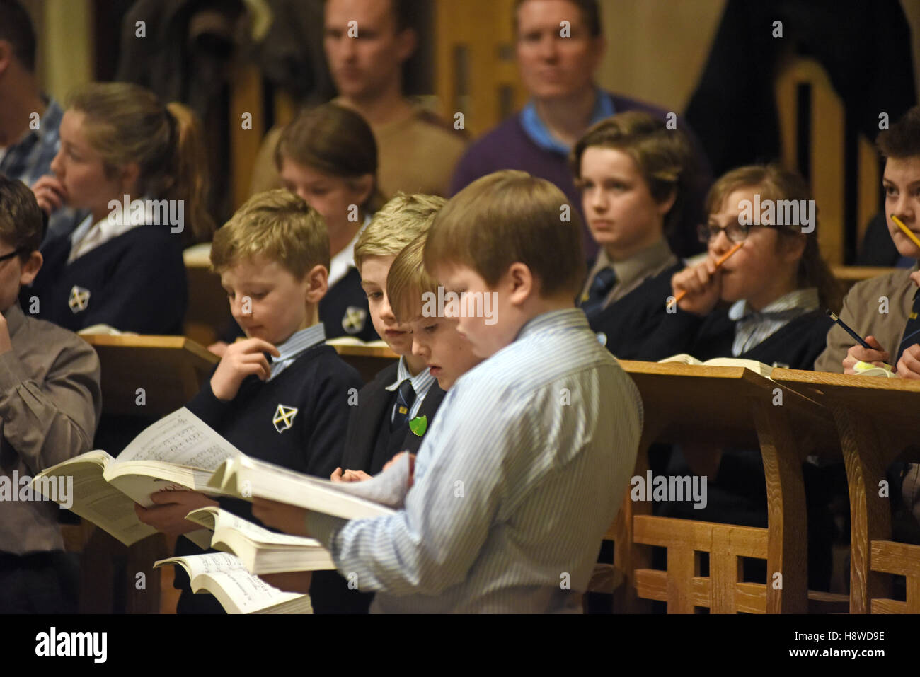Choristers being conducted by choir master at a recording session for a ...