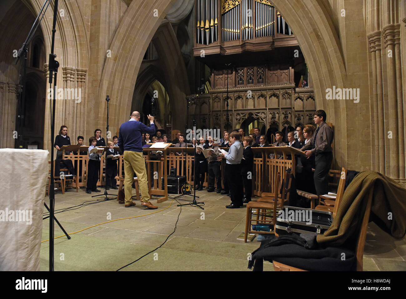 Choristers being conducted by choir master at a recording session for a ...