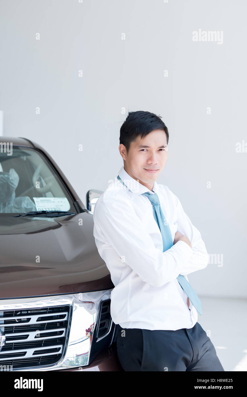 Handsome smiling man standing near new car, Dream comes true,auto ...