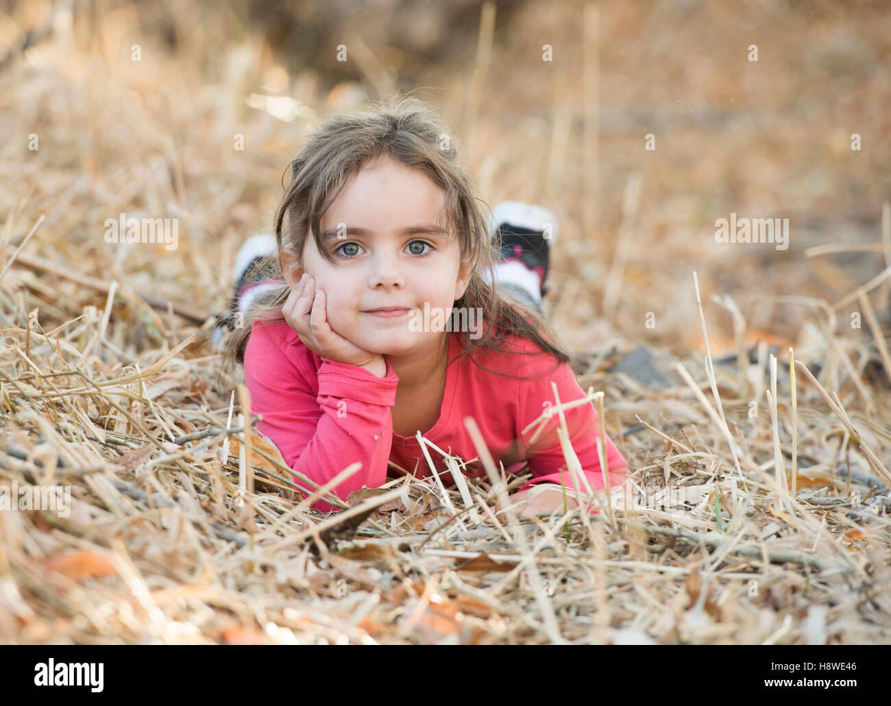 Little Girl with Long Hair Playing Outside in a Natural Environment with Trees and Foliage Stock ...