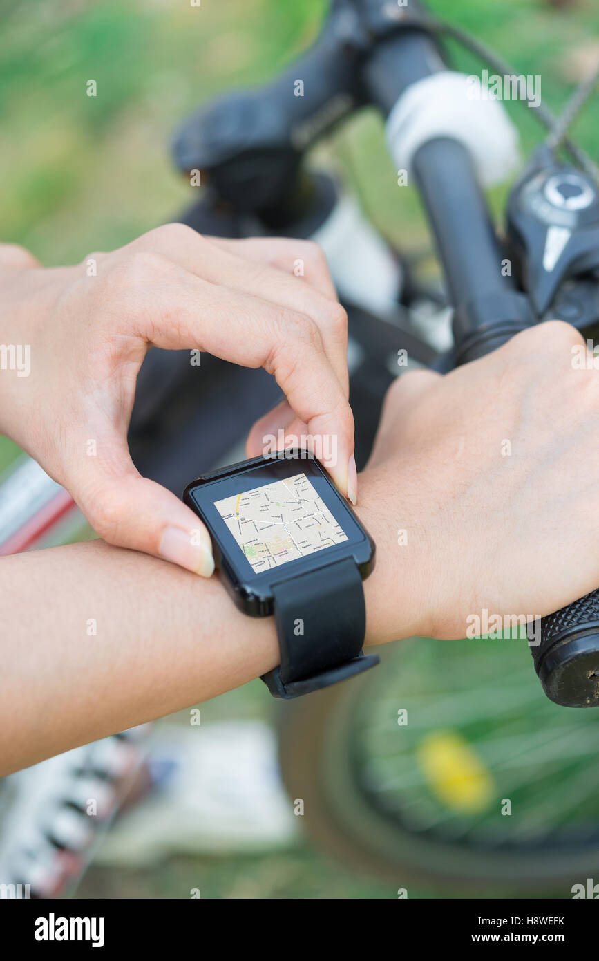 Close-up smart watch on arm women to ride a bicycle, navigation concept ...
