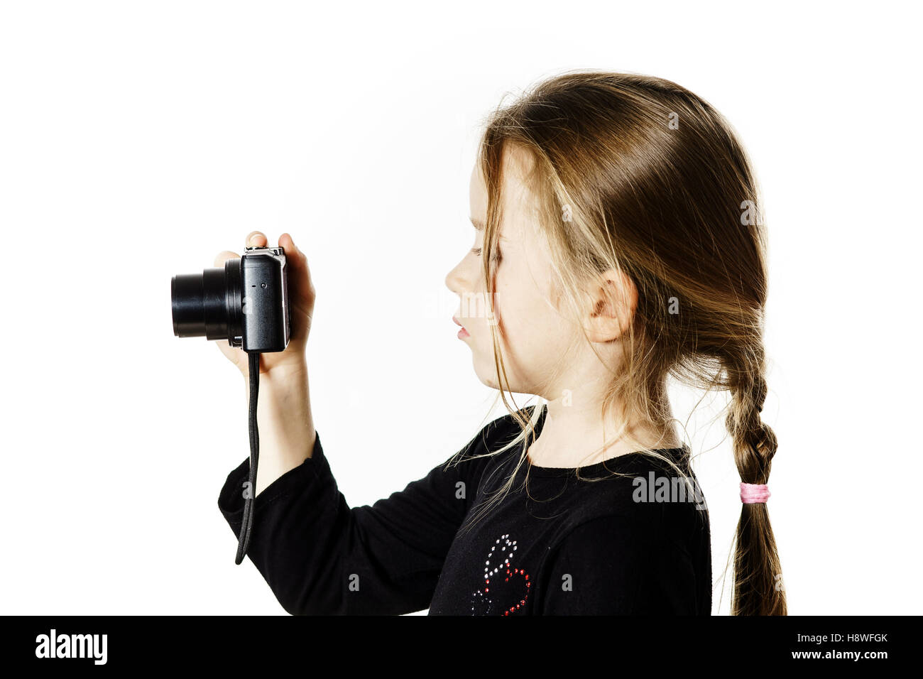 Cute little girl with compact digital camera, isolated on white ...