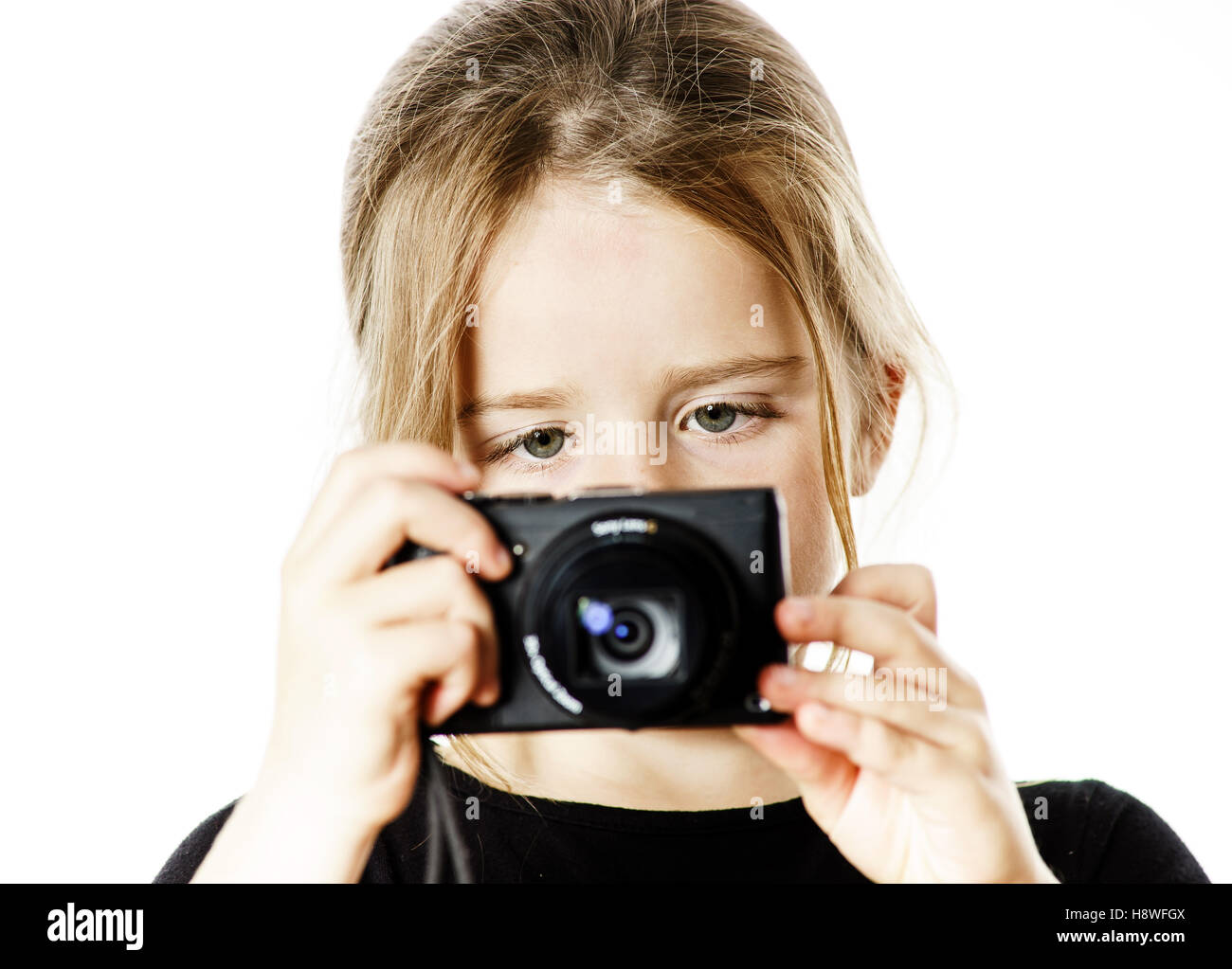 Cute little girl with compact digital camera, isolated on white ...