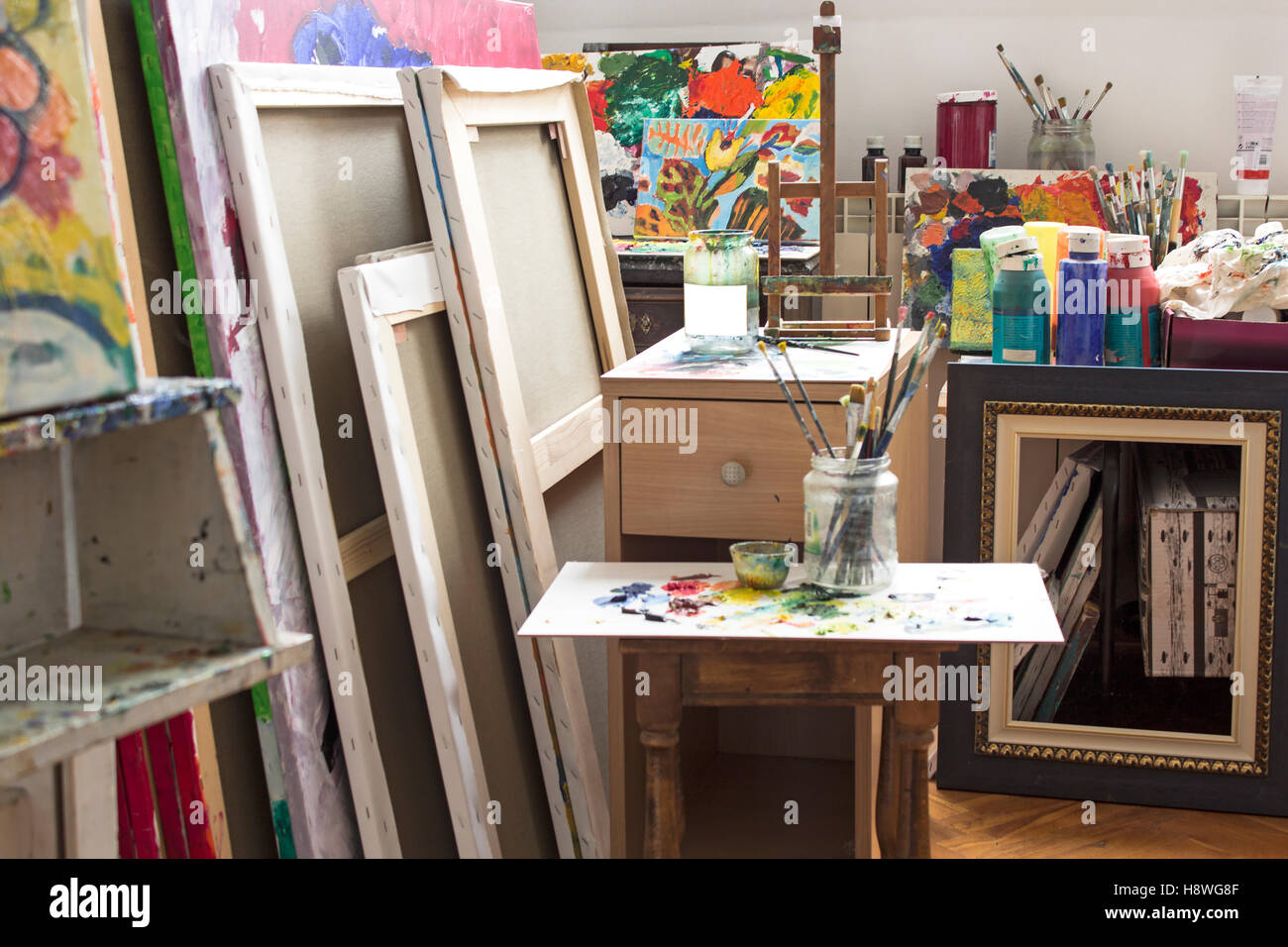 Art studio with paintings and painting materials Stock Photo - Alamy