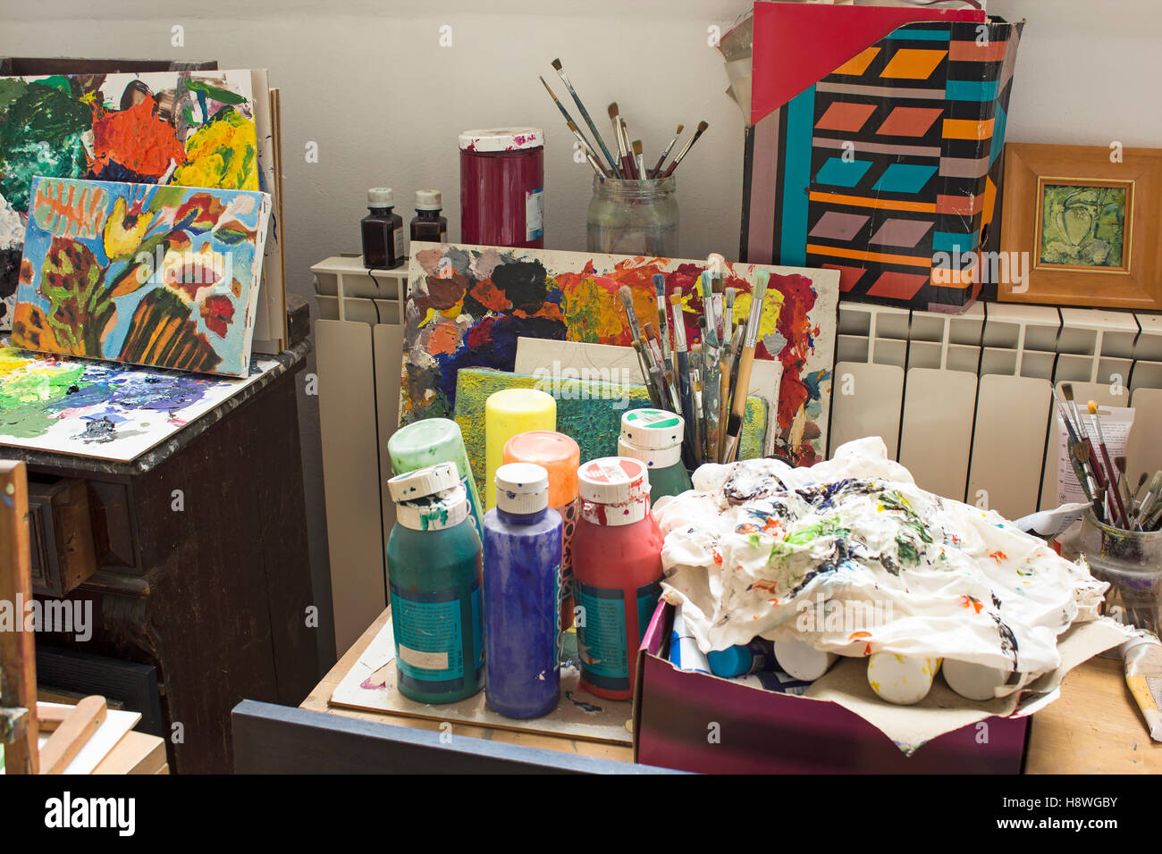 Art studio with paintings and painting materials Stock Photo - Alamy