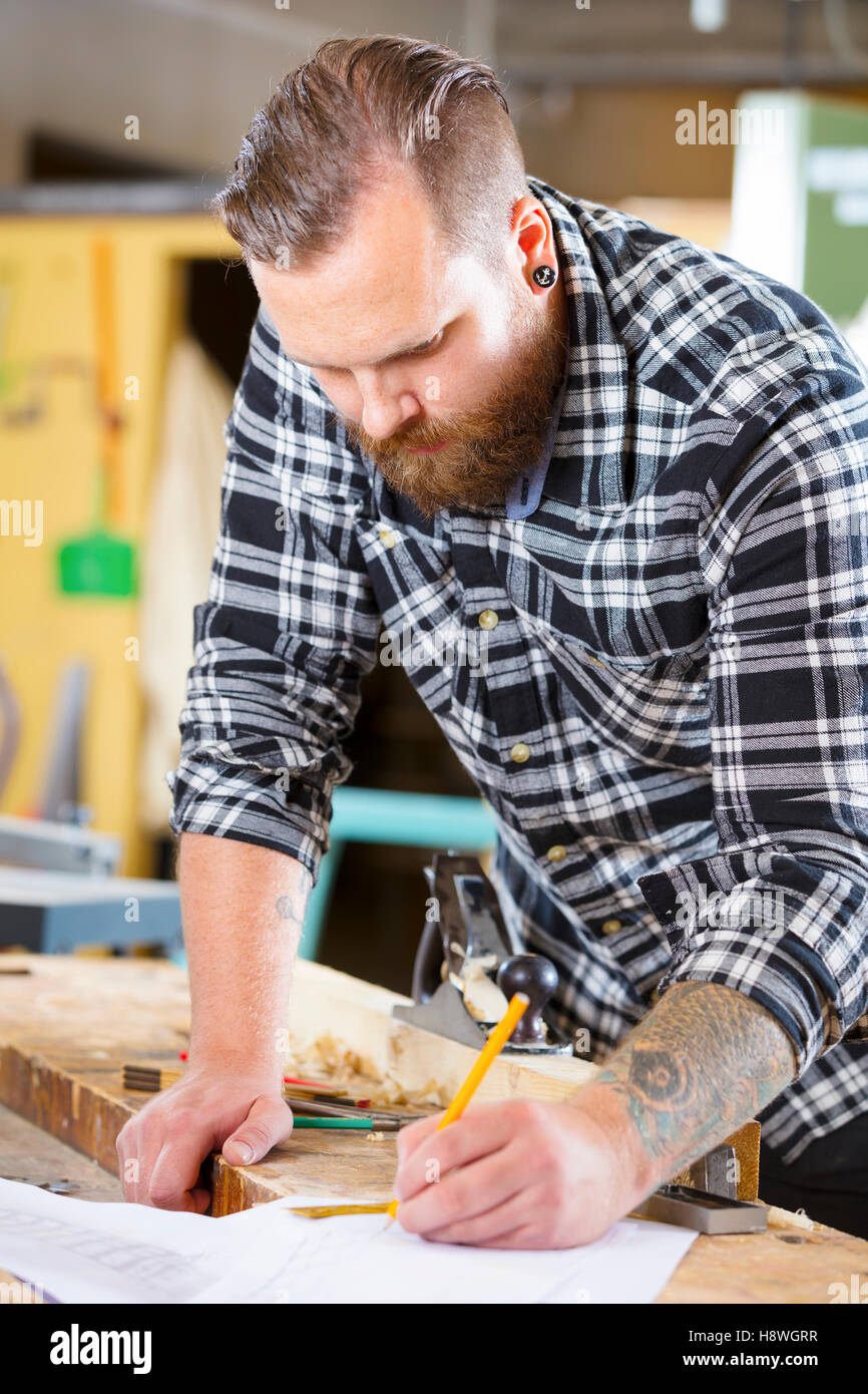 Carpenter plans work and notes at project drawings Stock Photo - Alamy