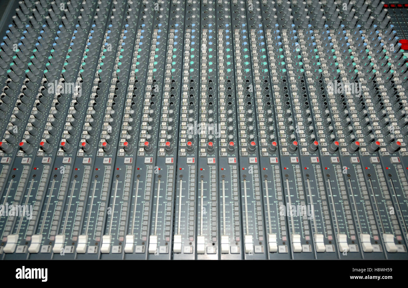 Audio mixing console in a recording studio. Faders and knobs of a sound ...