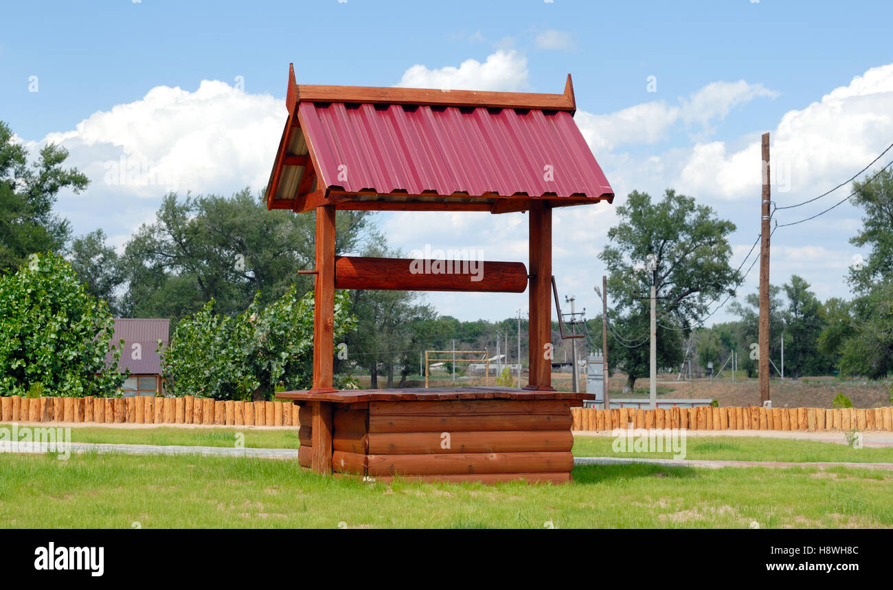 Wooden well stylised semi-antique against a rural landscape Stock Photo ...
