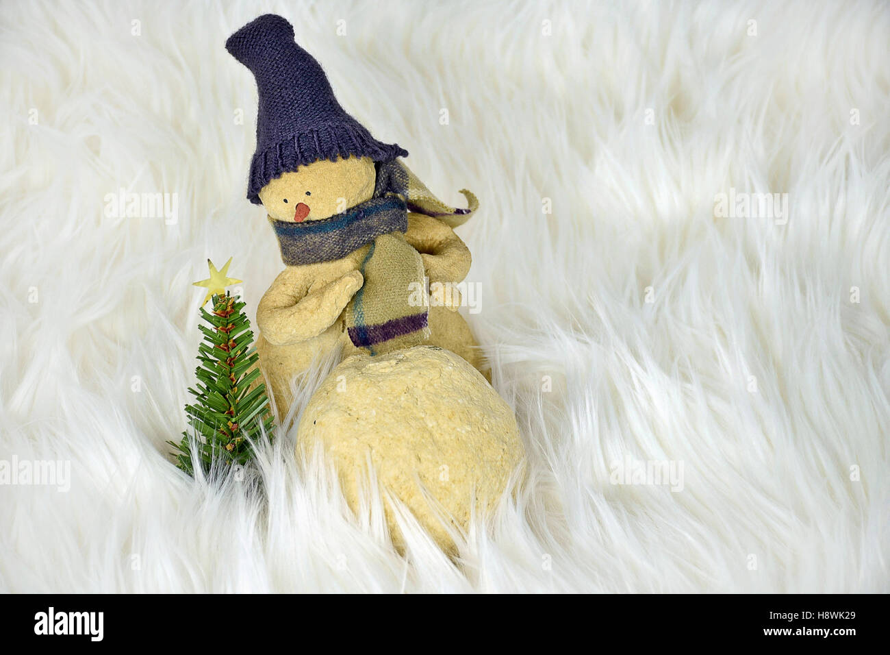 snowman with snowball and pine tree with star in white fur Stock Photo ...