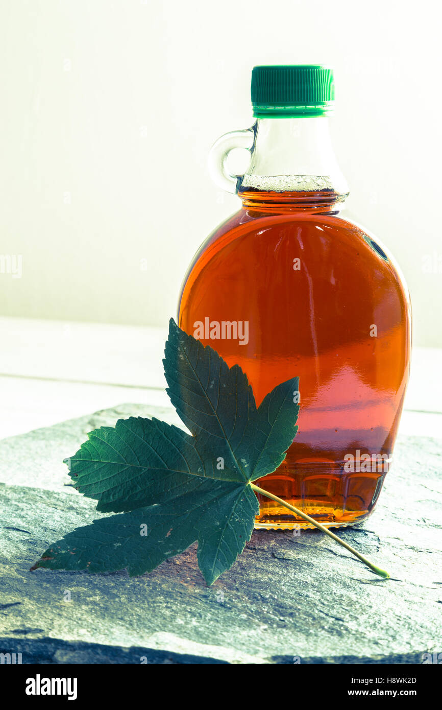 Maple syrup in a bottle with maple leaf Stock Photo - Alamy