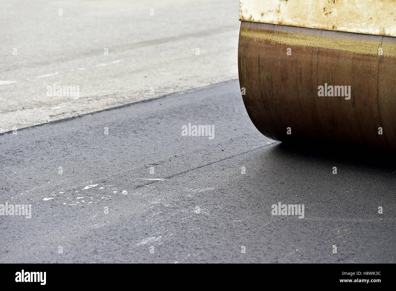 Asphalt paving with a steel wheel roller Stock Photo - Alamy