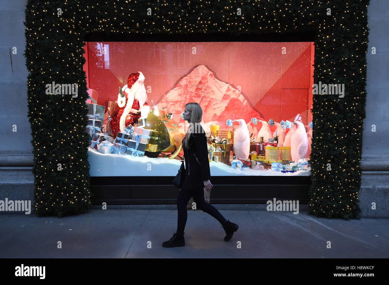 A woman passes a Selfridges window display on Oxford street in London ...
