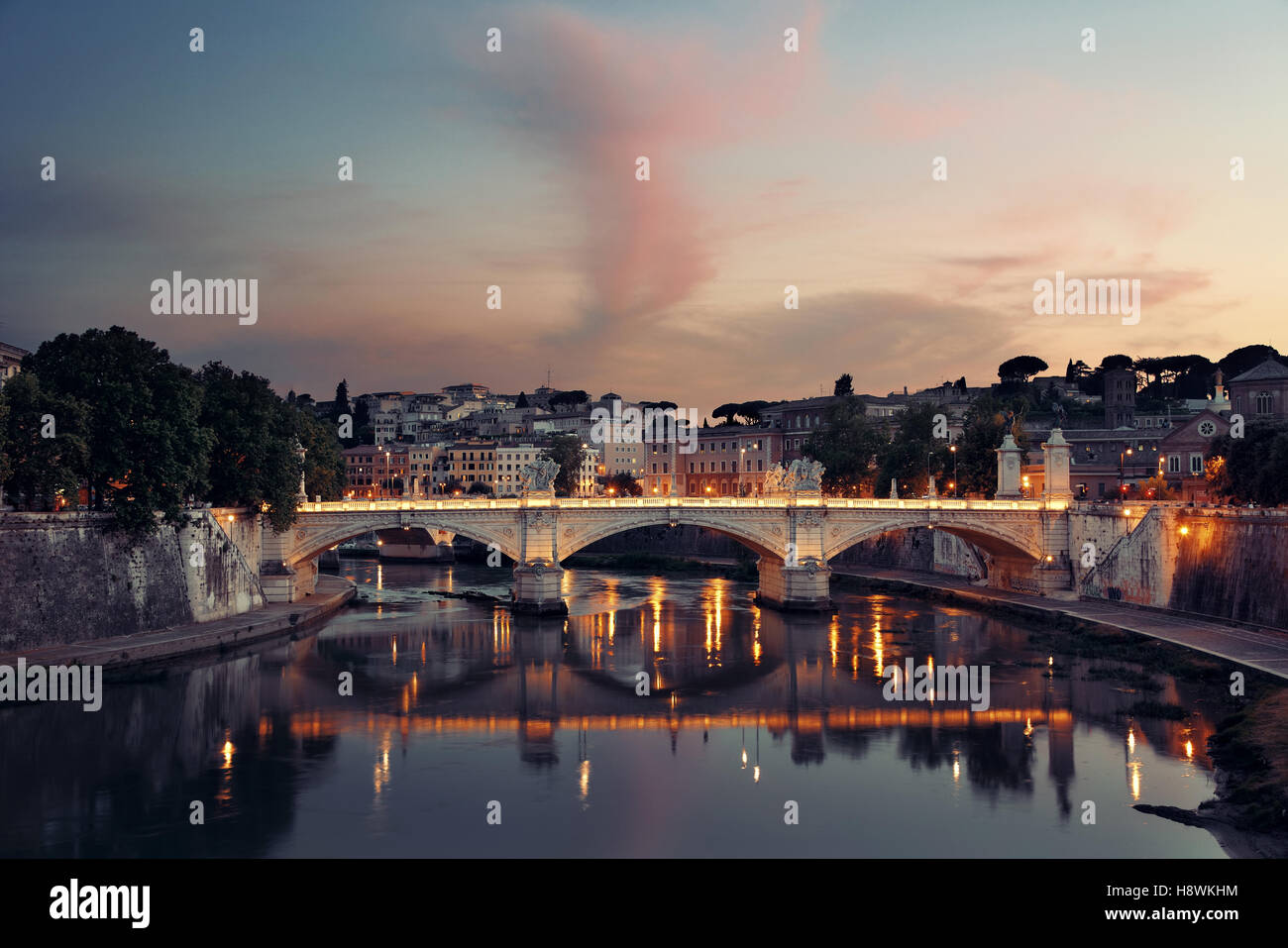 River Tiber and Rome ancient architecture with colorful sky at sunset ...