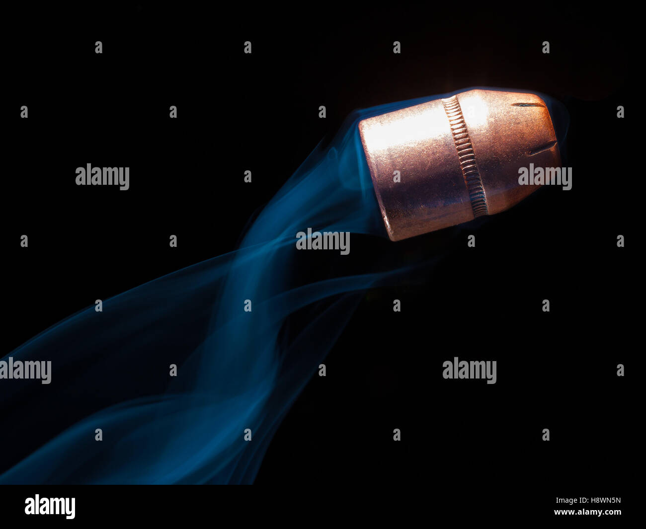 Pistol bullets on black with smoke trailing behind Stock Photo - Alamy