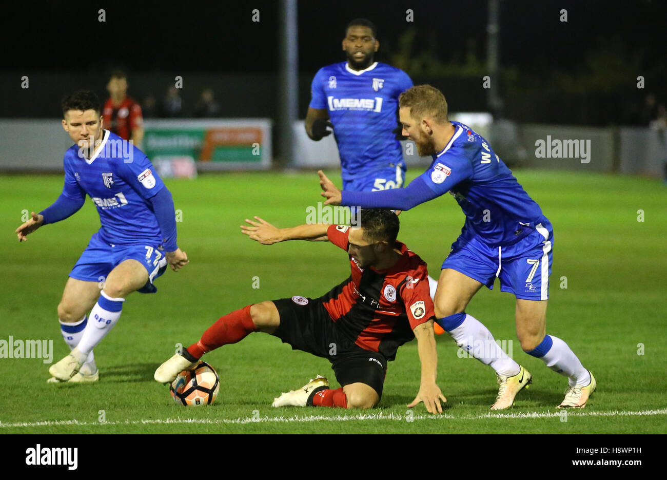 Brackley Town's Ellis Myles (centre) under pressure form the Gillingham ...