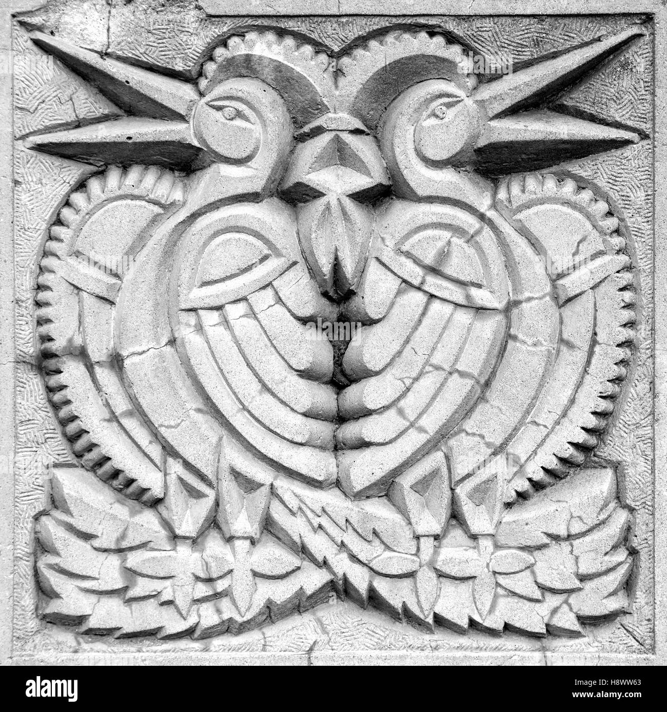 two fairy birds, stone bas-relief on the wall Stock Photo - Alamy