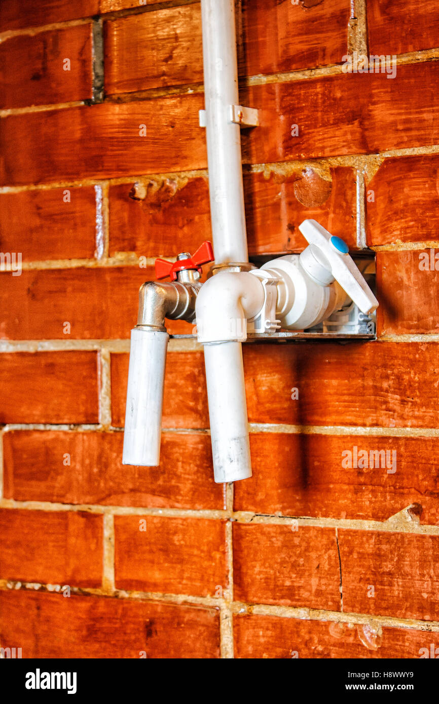 two white plastic taps in rustic bath closeup Stock Photo - Alamy
