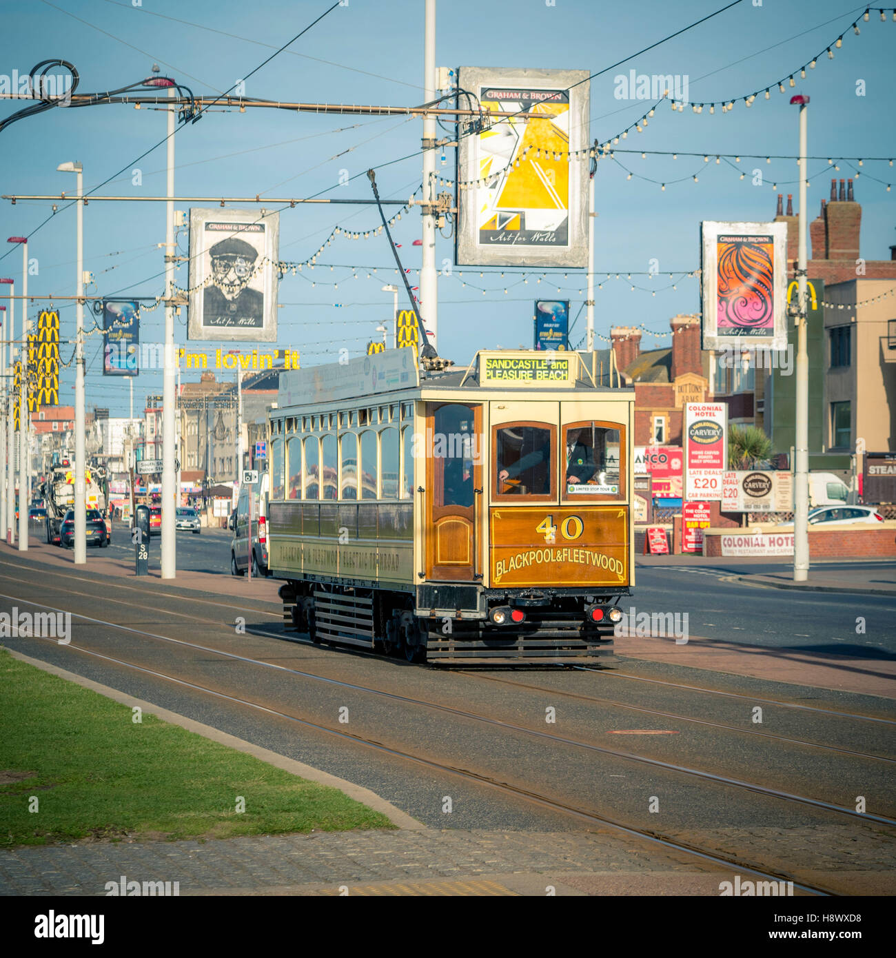 Traditional tram running along seafront promenade, Blackpool ...