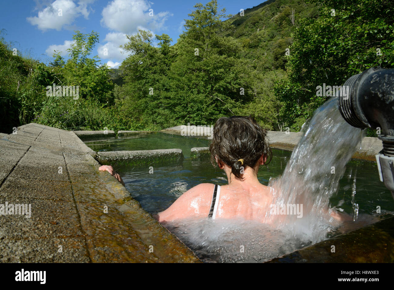Woman in hot sulfur spring - Corse France Stock Photo - Alamy
