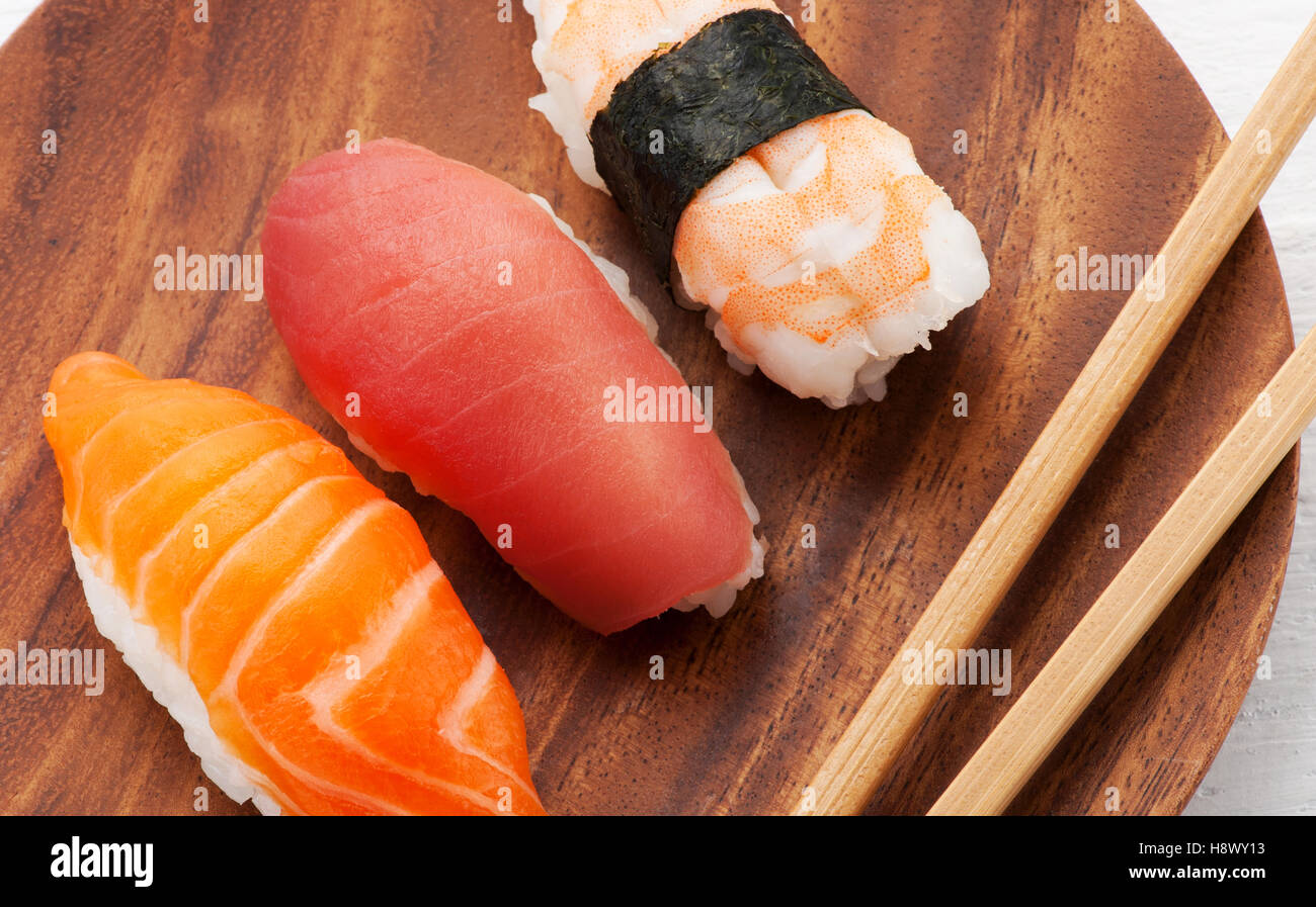 Three assorted Nighiri sushi made from mounds of rice topped with fresh ...