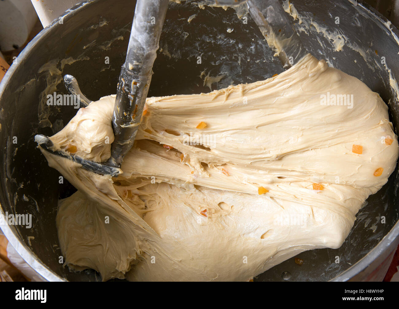 Mixing dough in a bakery with a view into an industrial mixer with a ...