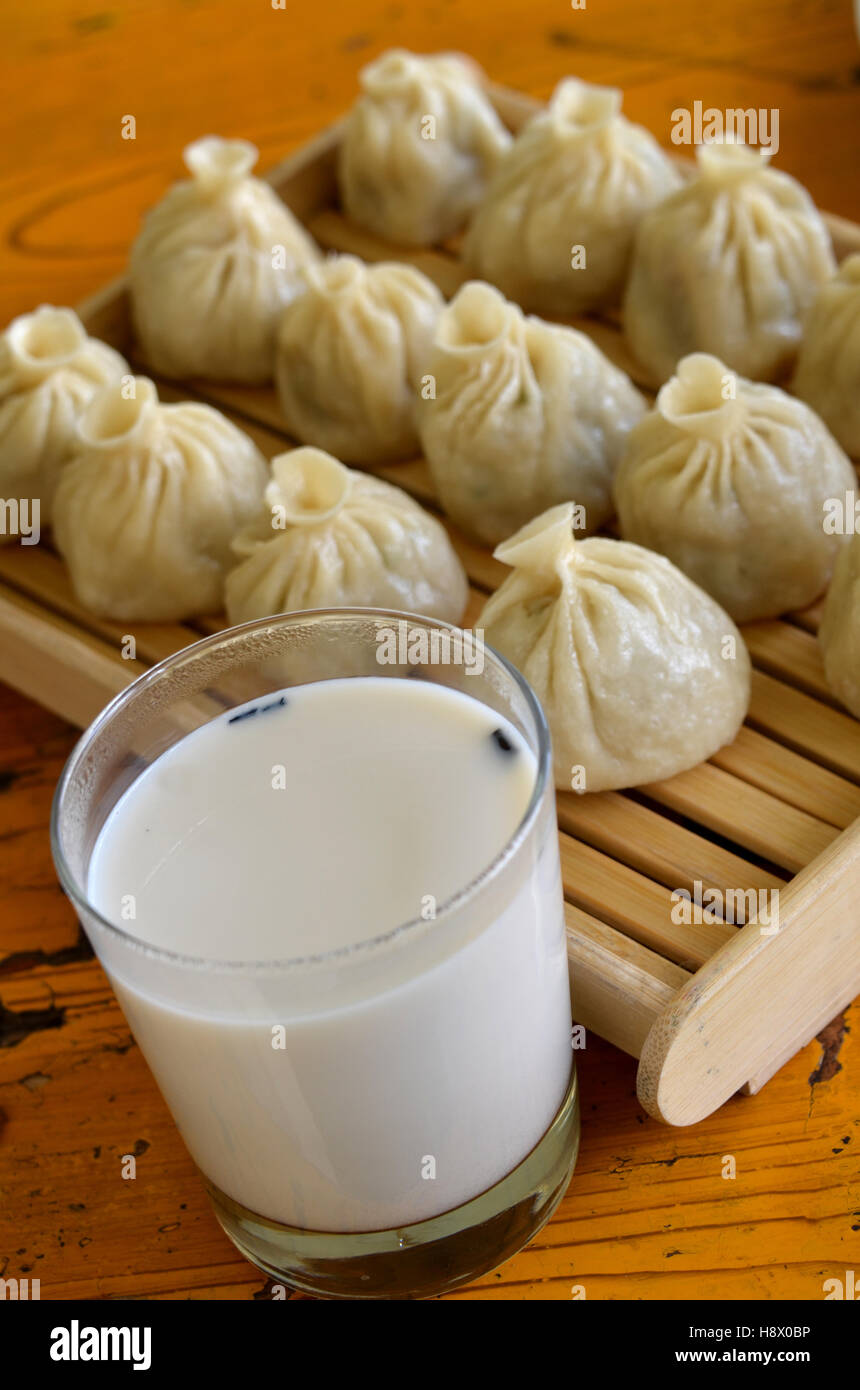 Glass of tea with yak milk and momos - Tibet China Stock Photo - Alamy