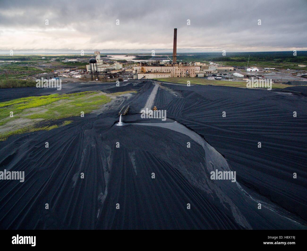 Aerial view of vast field of black slag surrounding Vale Inco Manitoba ...