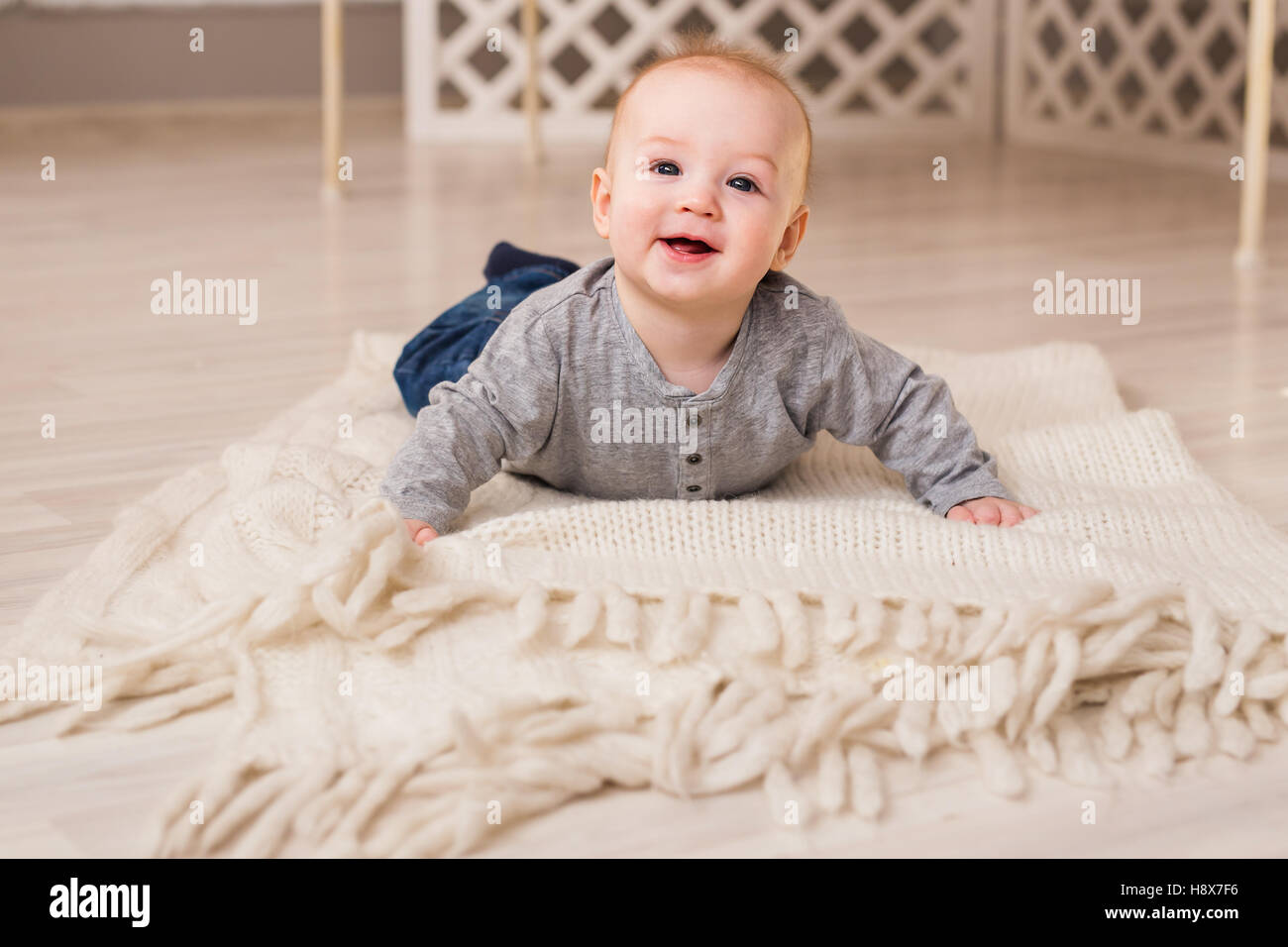 Laughing Baby Boy Lying On Tummy At Home Stock Photo - Alamy