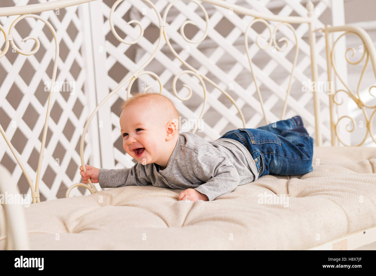 Laughing Baby Boy Lying On Tummy At Home Stock Photo - Alamy
