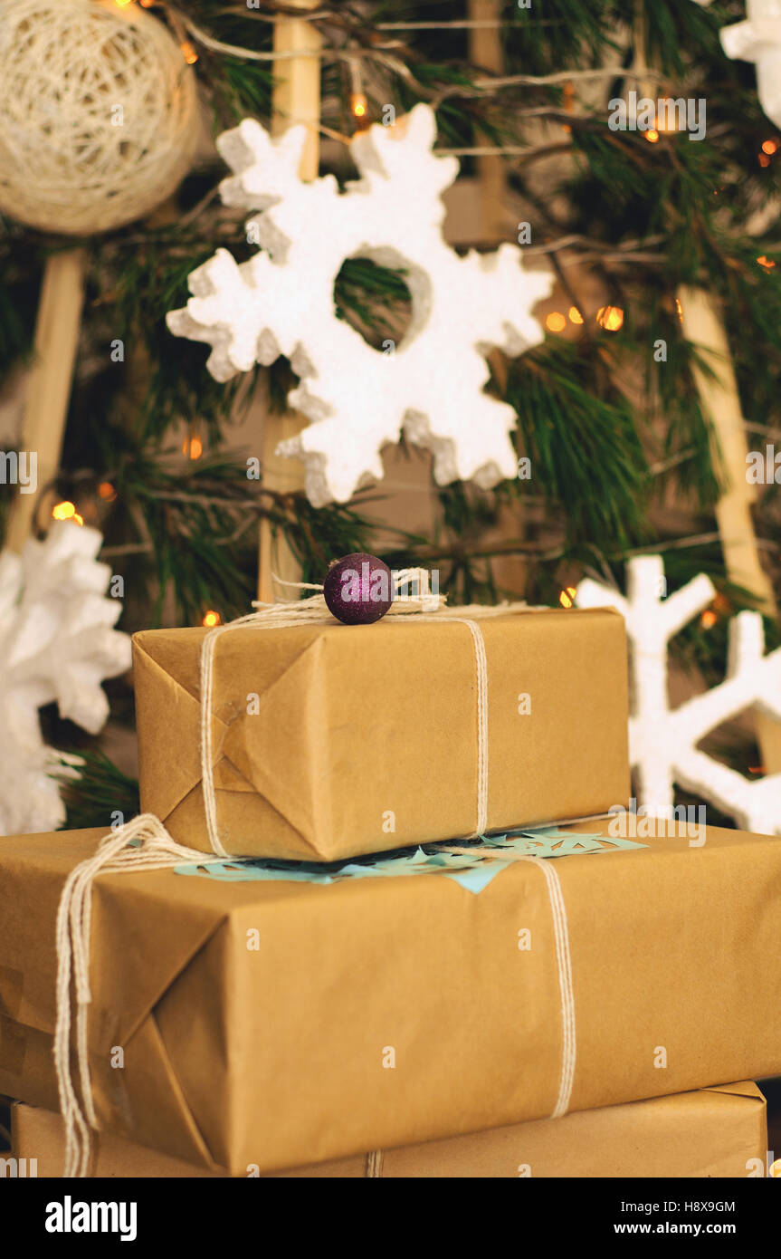 Christmas gifts under the tree ecological style Stock Photo - Alamy