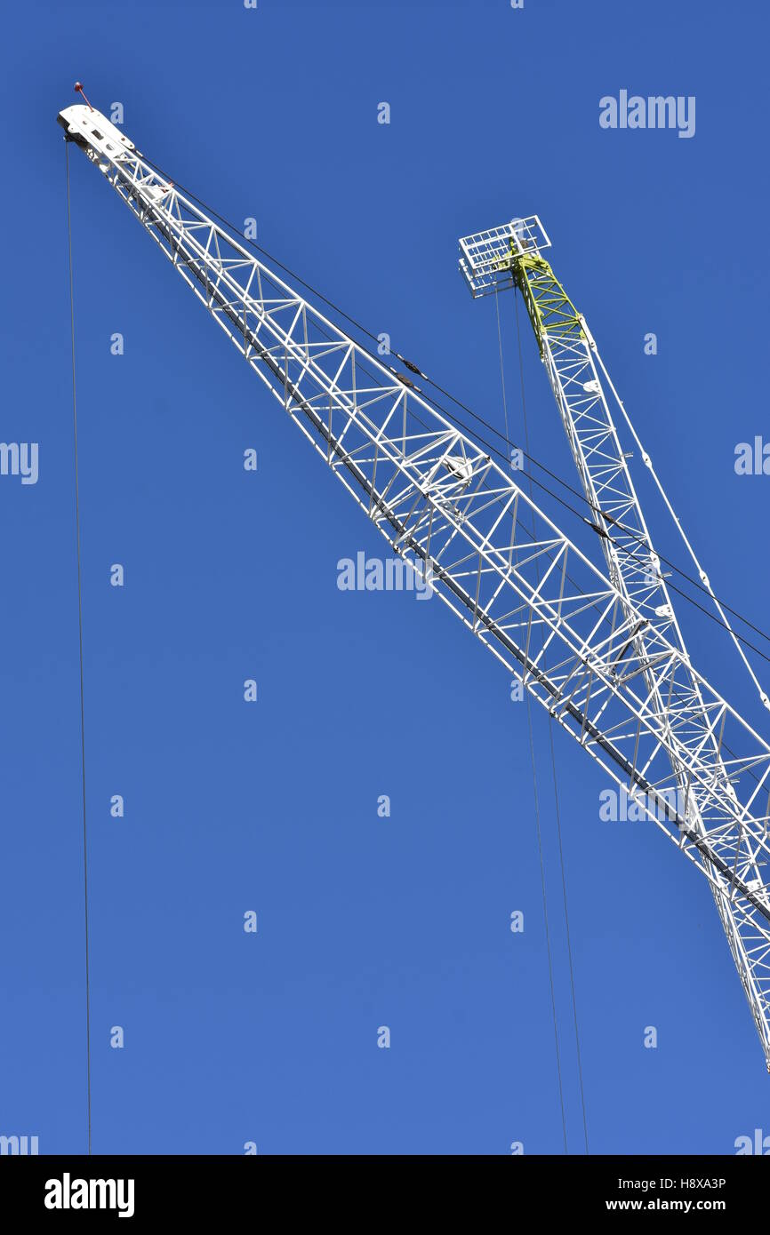 steel tower crane arms against blue sky background Stock Photo - Alamy