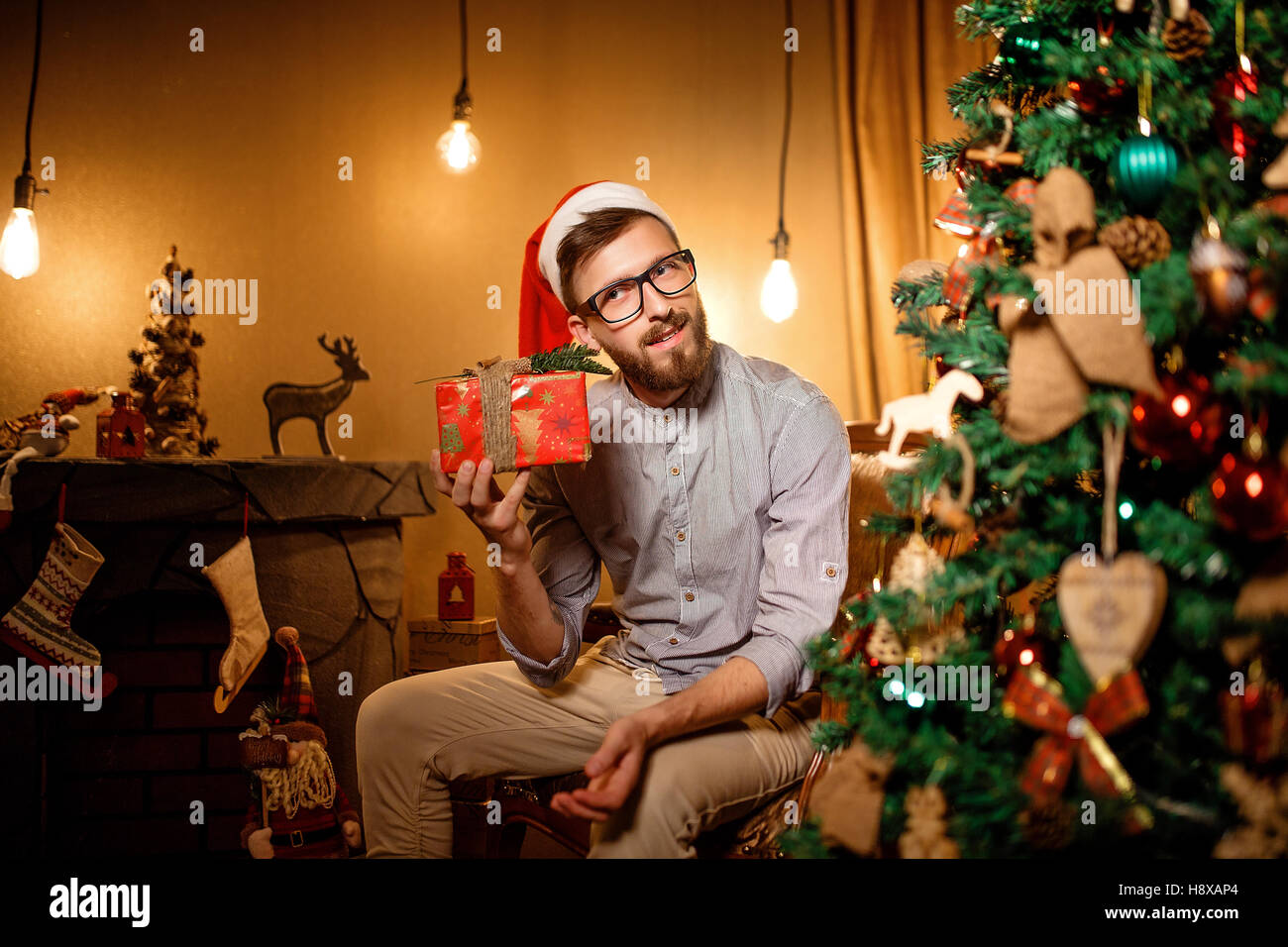 Young Man Holding Small Present Stock Photo - Alamy