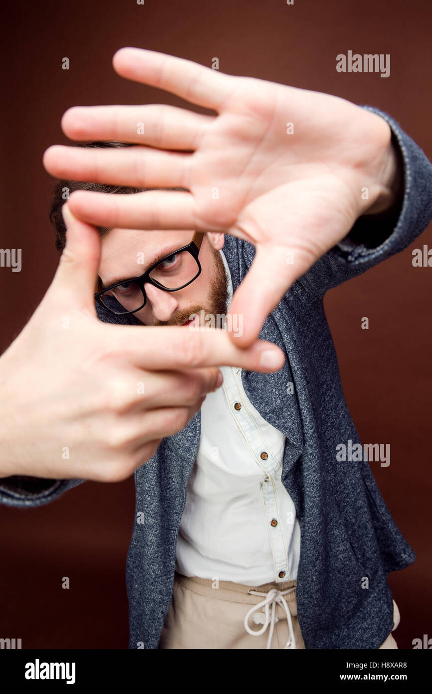 Male making camera from hands Stock Photo - Alamy