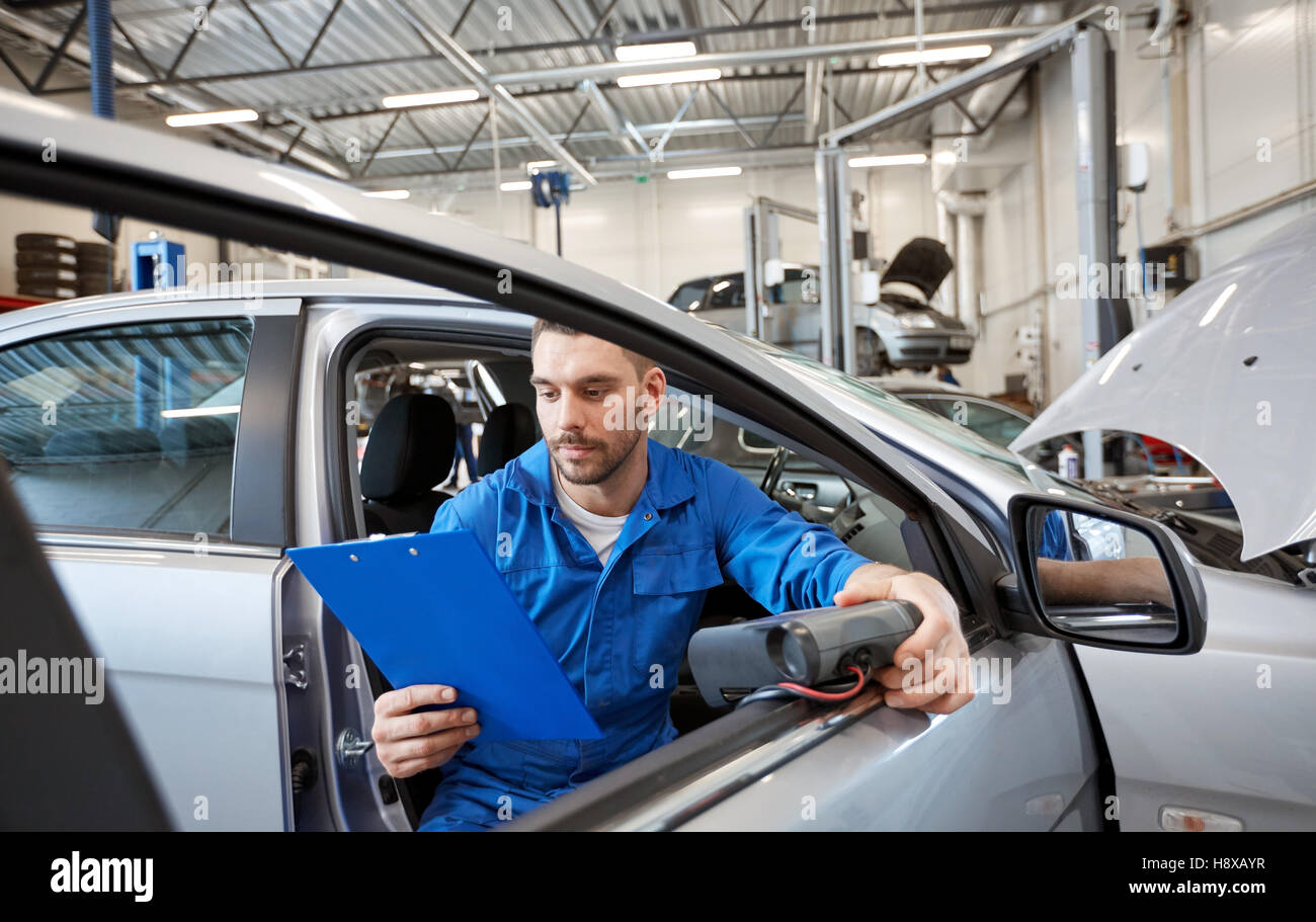 mechanic man with diagnostic scanner at car shop Stock Photo - Alamy