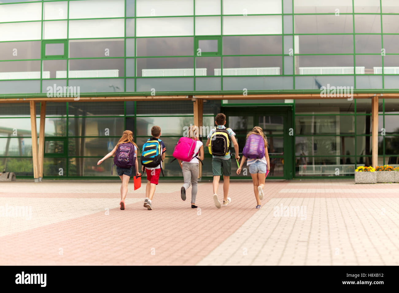 group of happy elementary school students running Stock Photo - Alamy