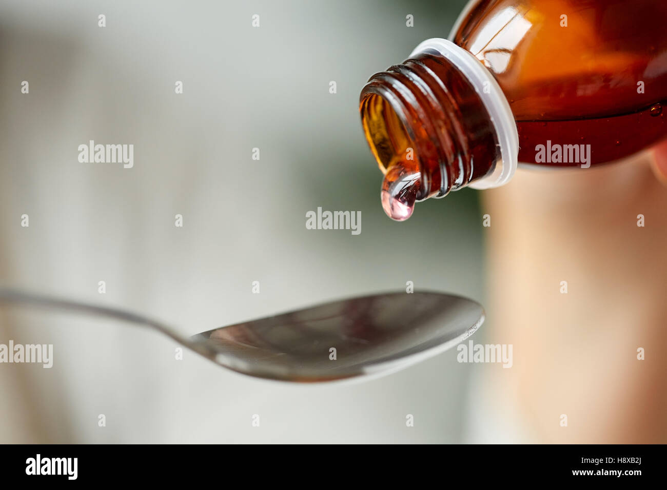 medication or antipyretic syrup and spoon Stock Photo - Alamy