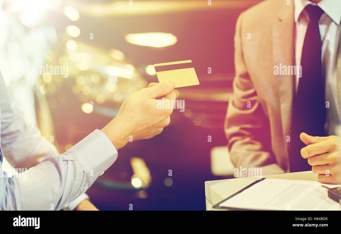 customer giving credit card to car dealer in salon Stock Photo - Alamy