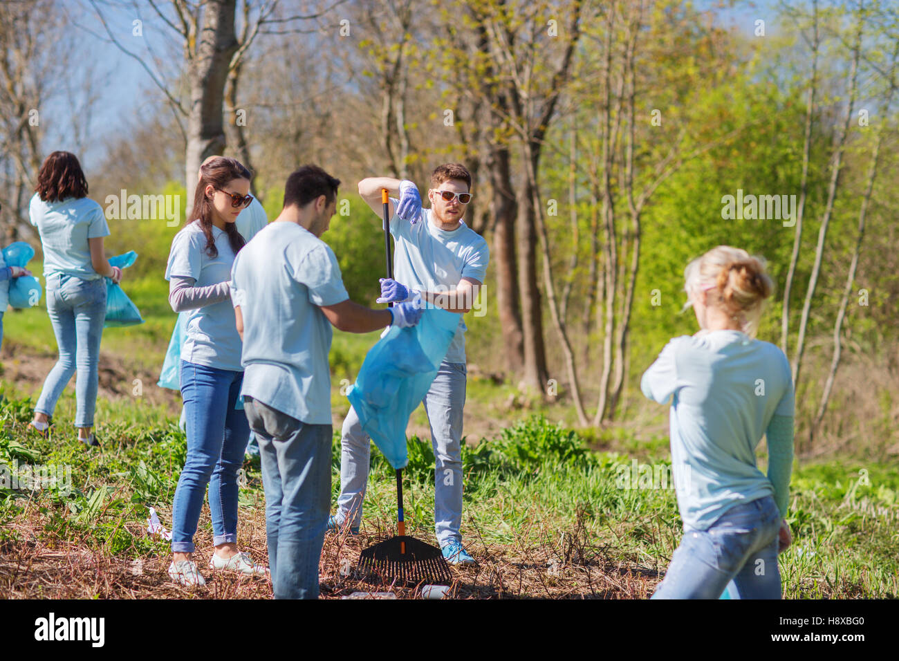 volunteers with garbage bags cleaning park area Stock Photo - Alamy