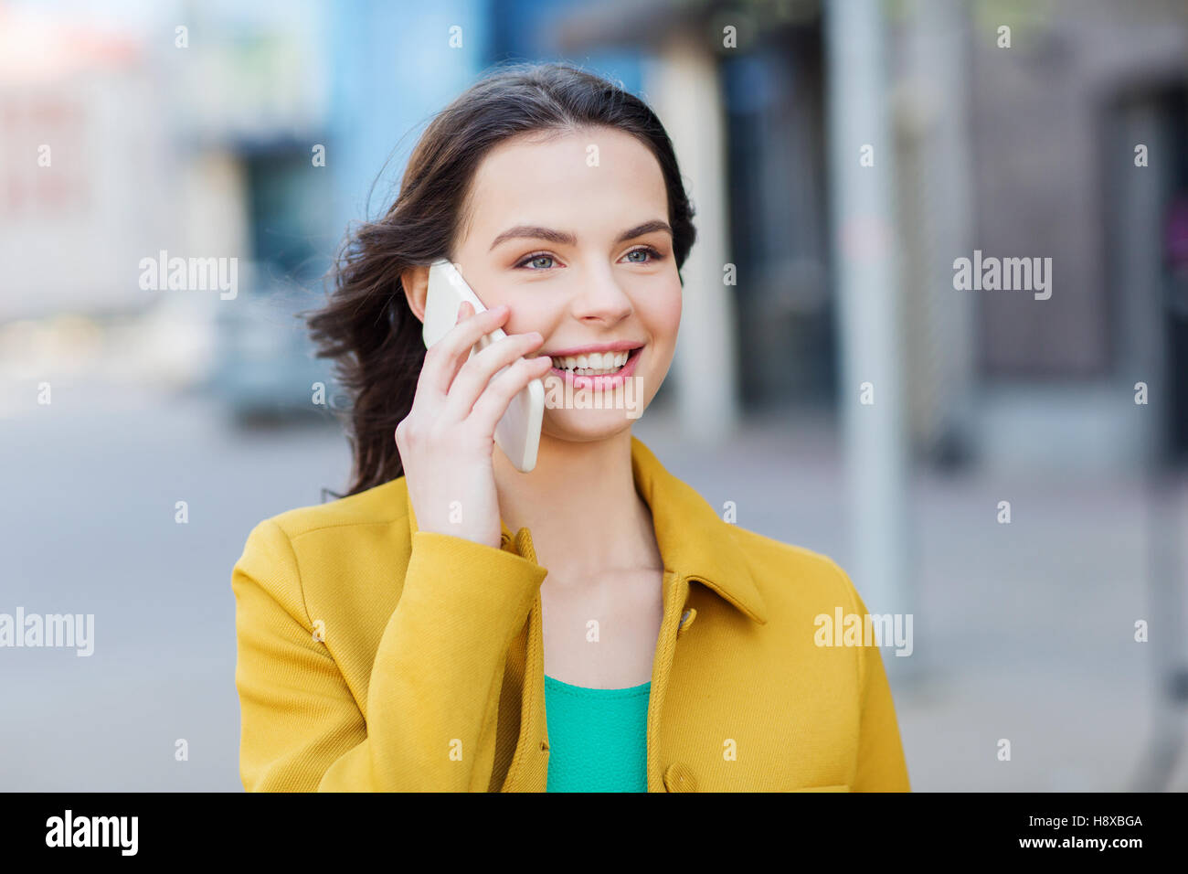 smiling young woman or girl calling on smartphone Stock Photo - Alamy