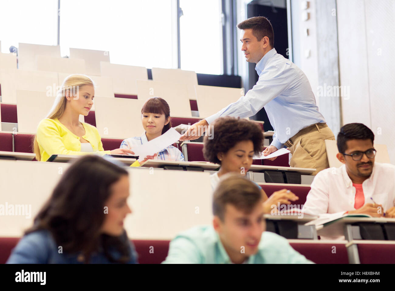 teacher giving test to students on lecture Stock Photo - Alamy