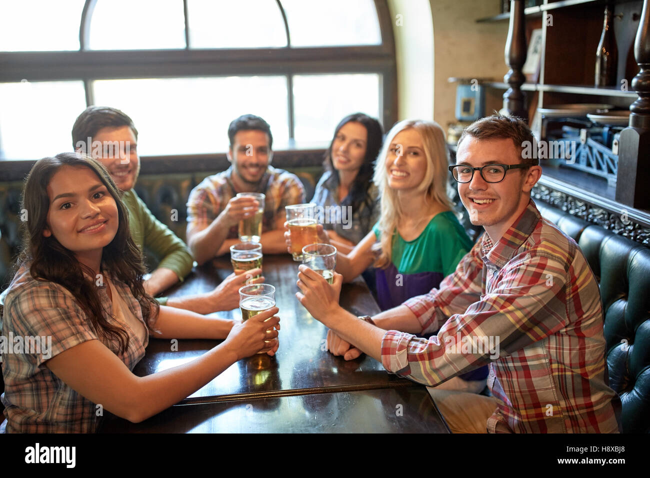 happy friends drinking beer at bar or pub Stock Photo - Alamy