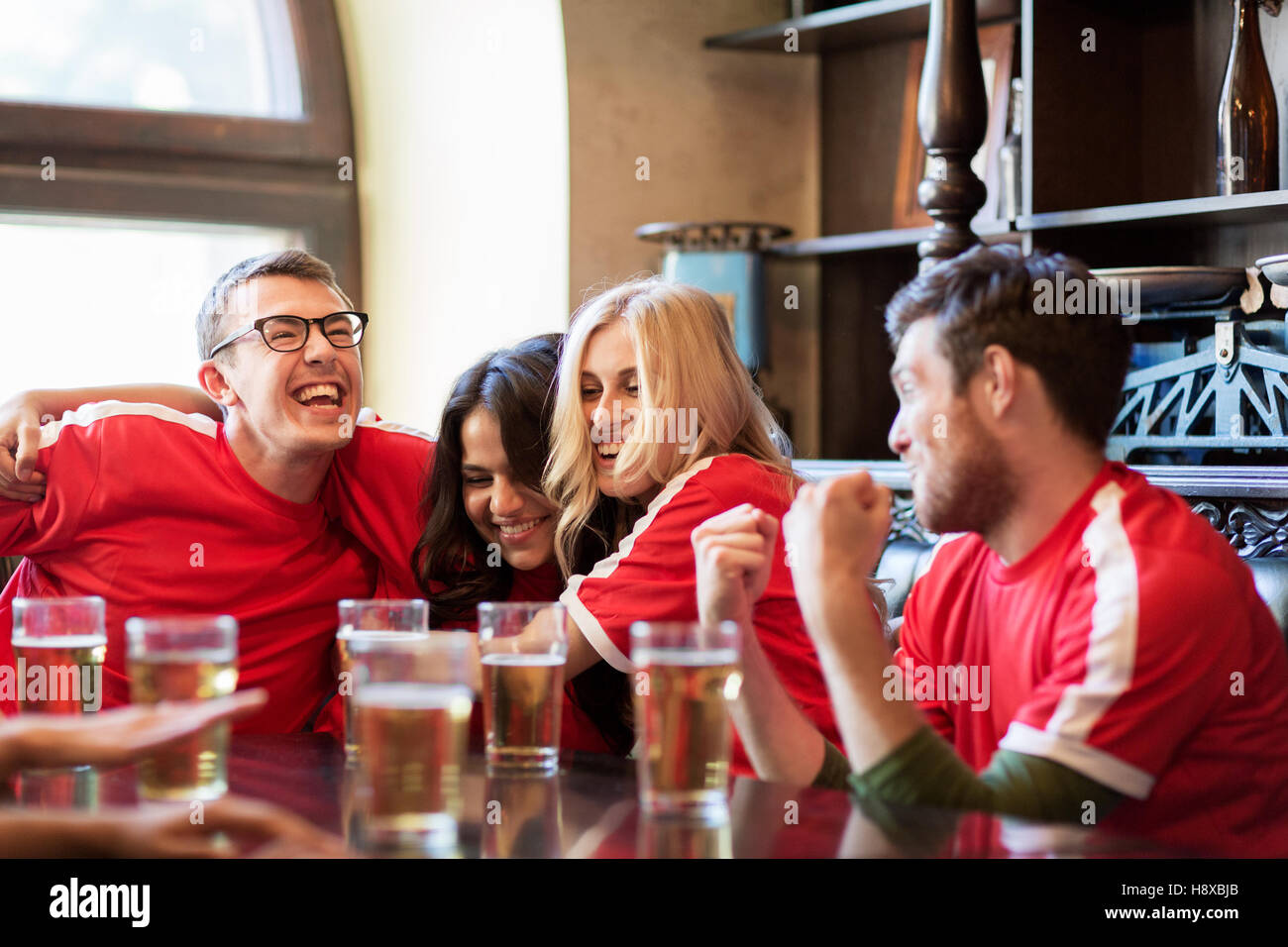 football fans or friends with beer at sport bar Stock Photo - Alamy