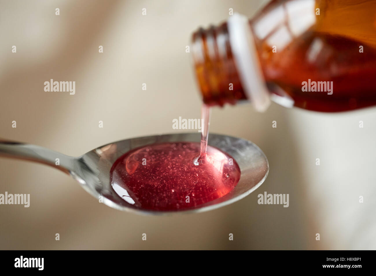 medication or antipyretic syrup and spoon Stock Photo - Alamy