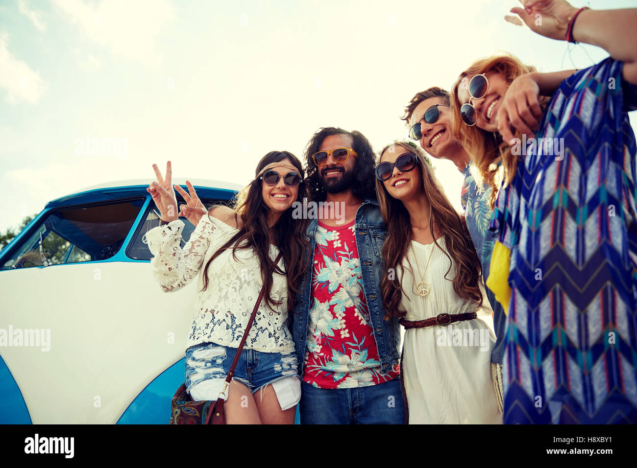 hippie friends over minivan car showing peace sign Stock Photo - Alamy