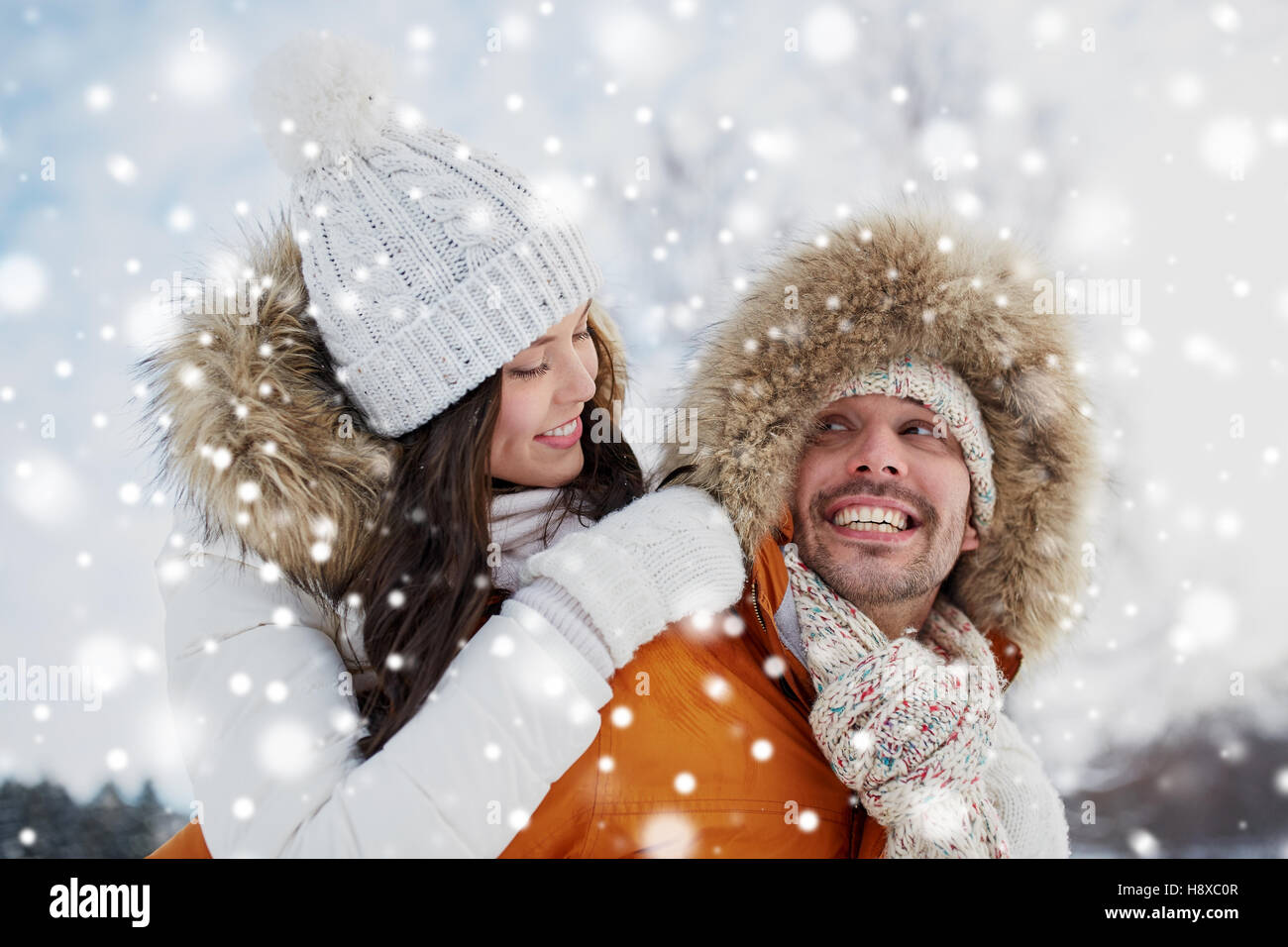 happy couple having fun over winter background Stock Photo - Alamy