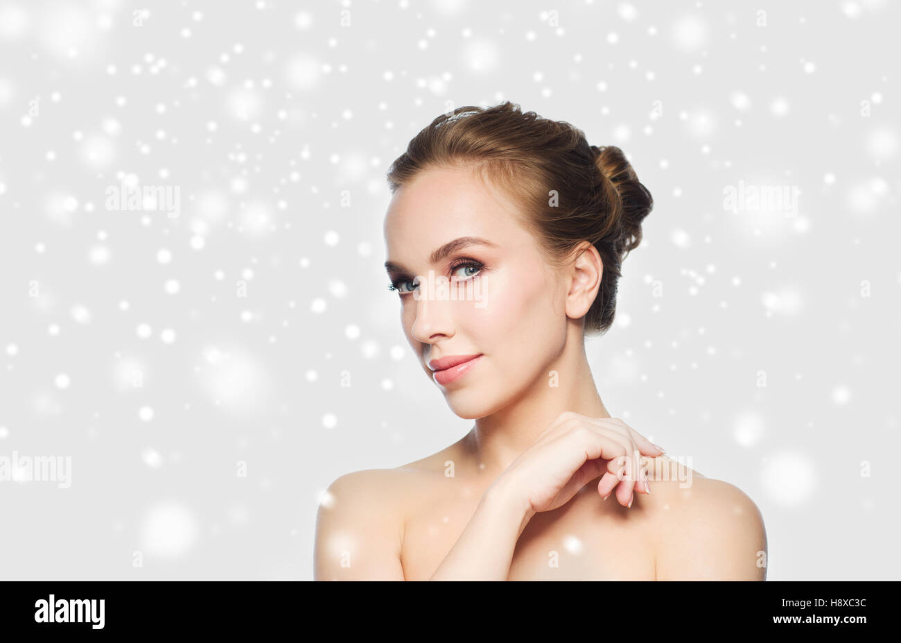 beautiful young woman face over snow Stock Photo - Alamy