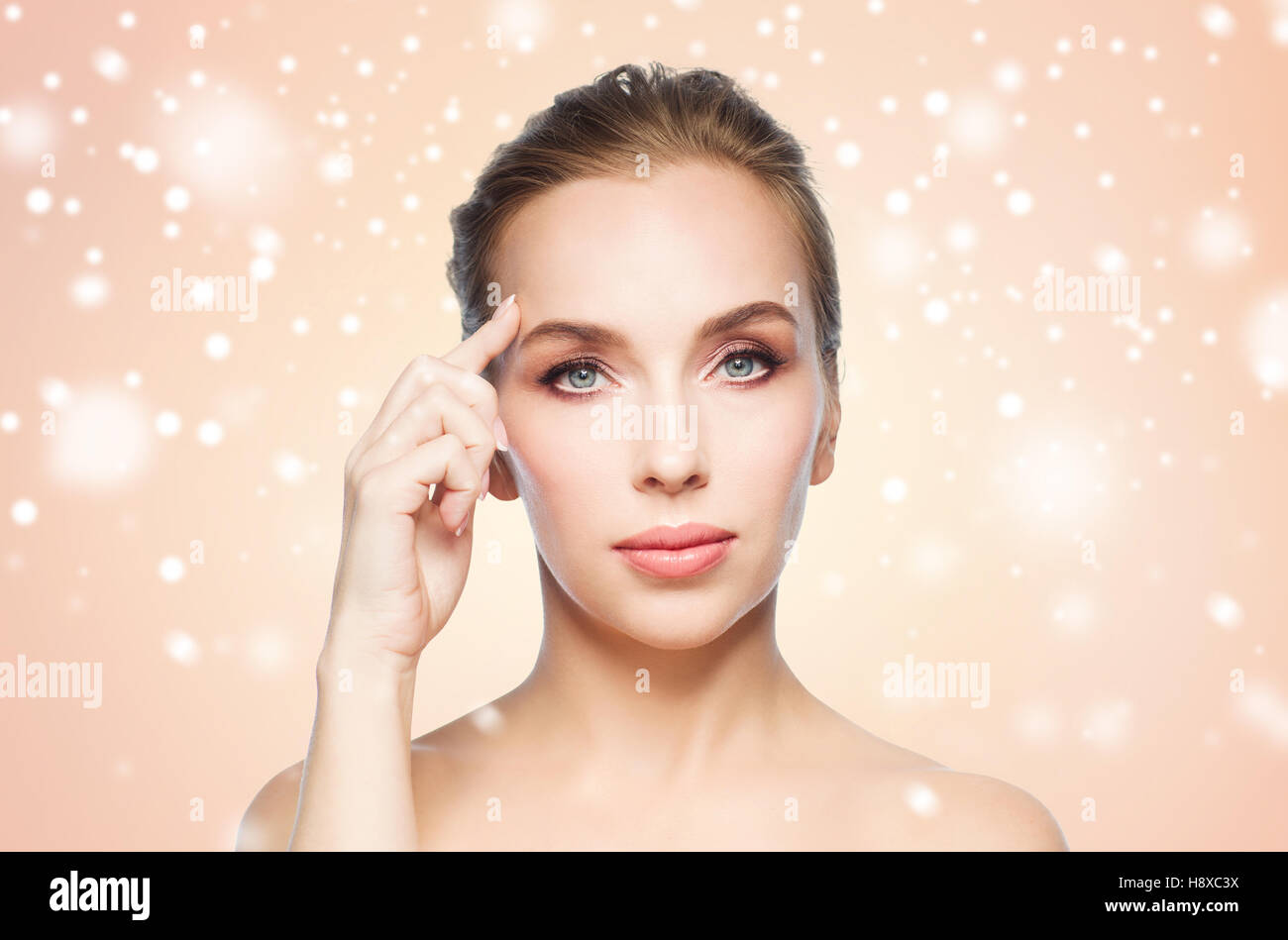 beautiful woman showing her forehead over snow Stock Photo - Alamy