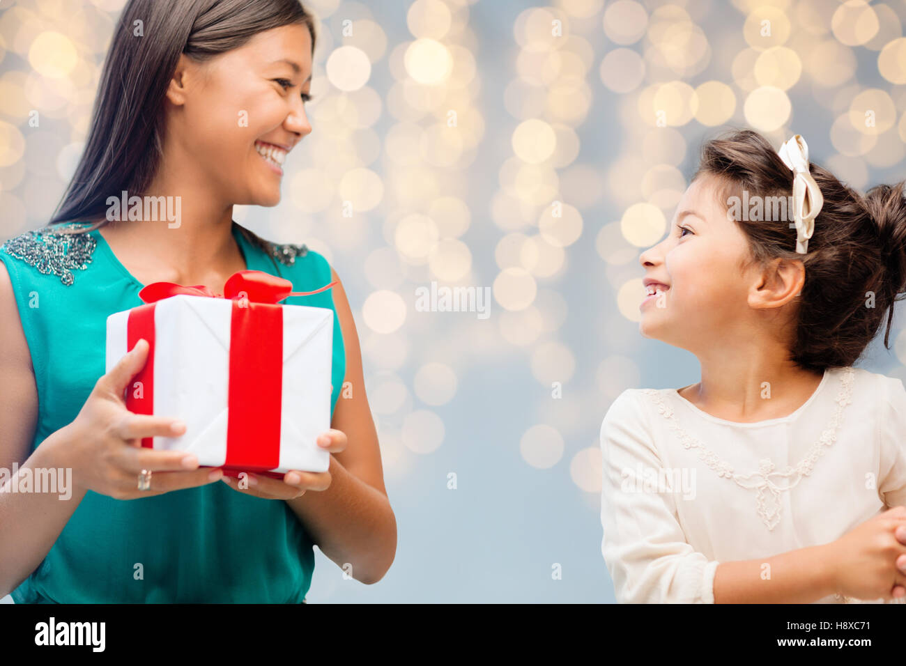 happy mother giving birthday present to her child Stock Photo - Alamy
