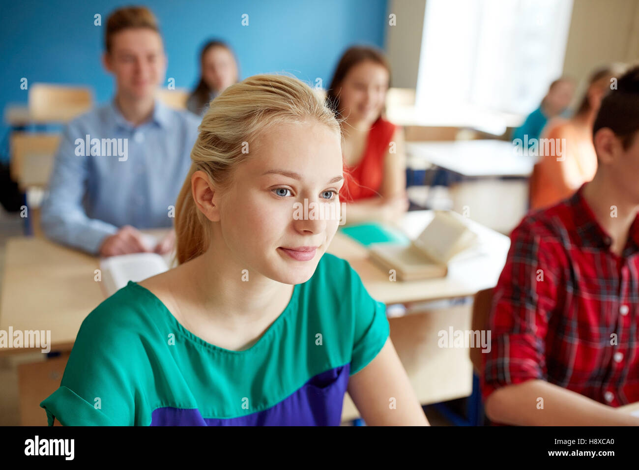 group of students with books at school lesson Stock Photo - Alamy